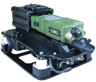 Combination vehicle adapter and charging station for VHF military ...